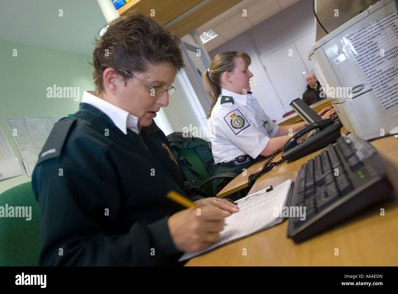 Two ambulance workers in a control room UK Stock Photo - Alamy