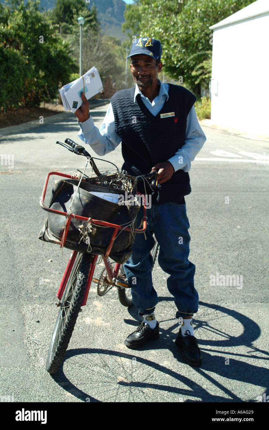 Postman on bicycle in Franschhoek South Africa RSA delivers letters on his round Stock Photo - Alamy