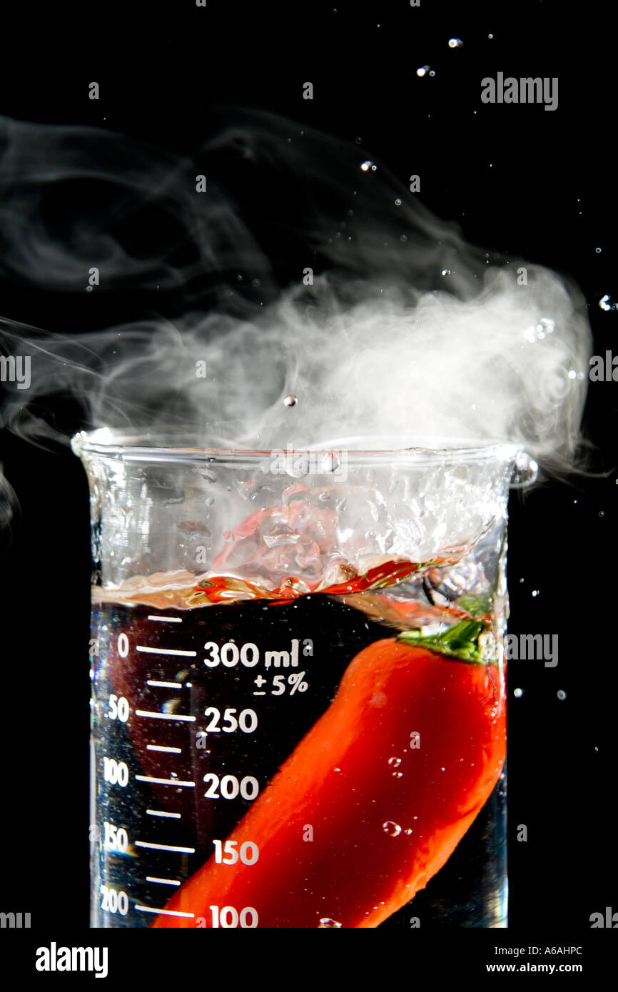 Red pepper boiling water in laboratory beaker Stock Photo - Alamy