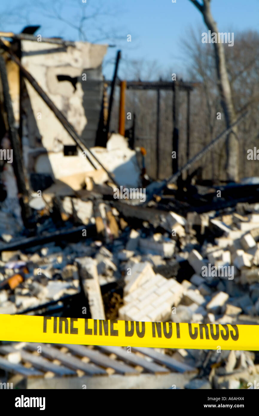 FIRE LINE yellow tape in front of burned building Stock Photo - Alamy