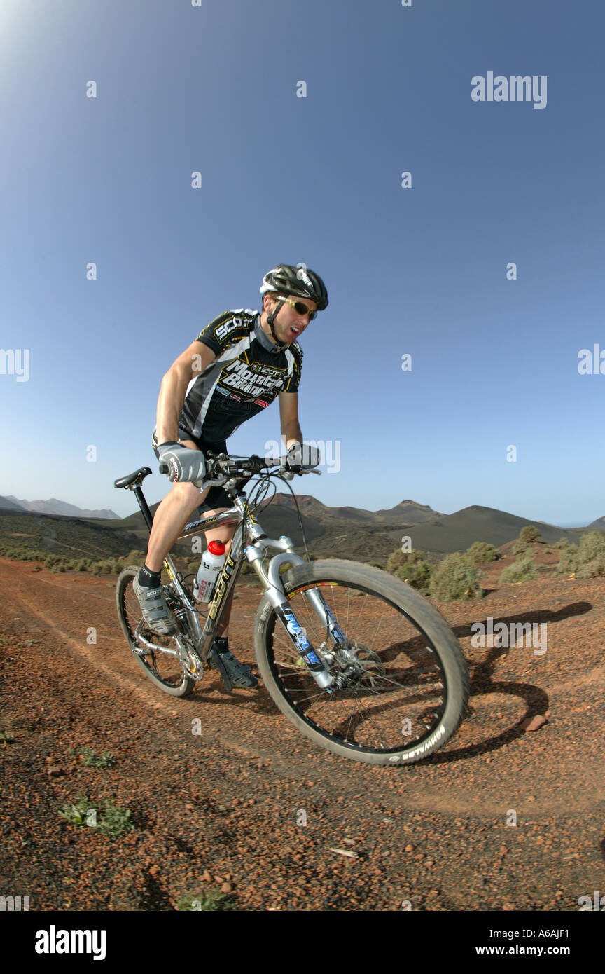 Mountain Biker climbing uphill Stock Photo - Alamy