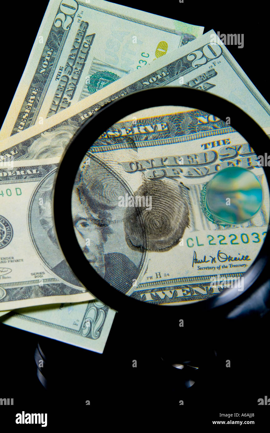 Magnifying glass with fingerprint on United States currency Stock Photo ...