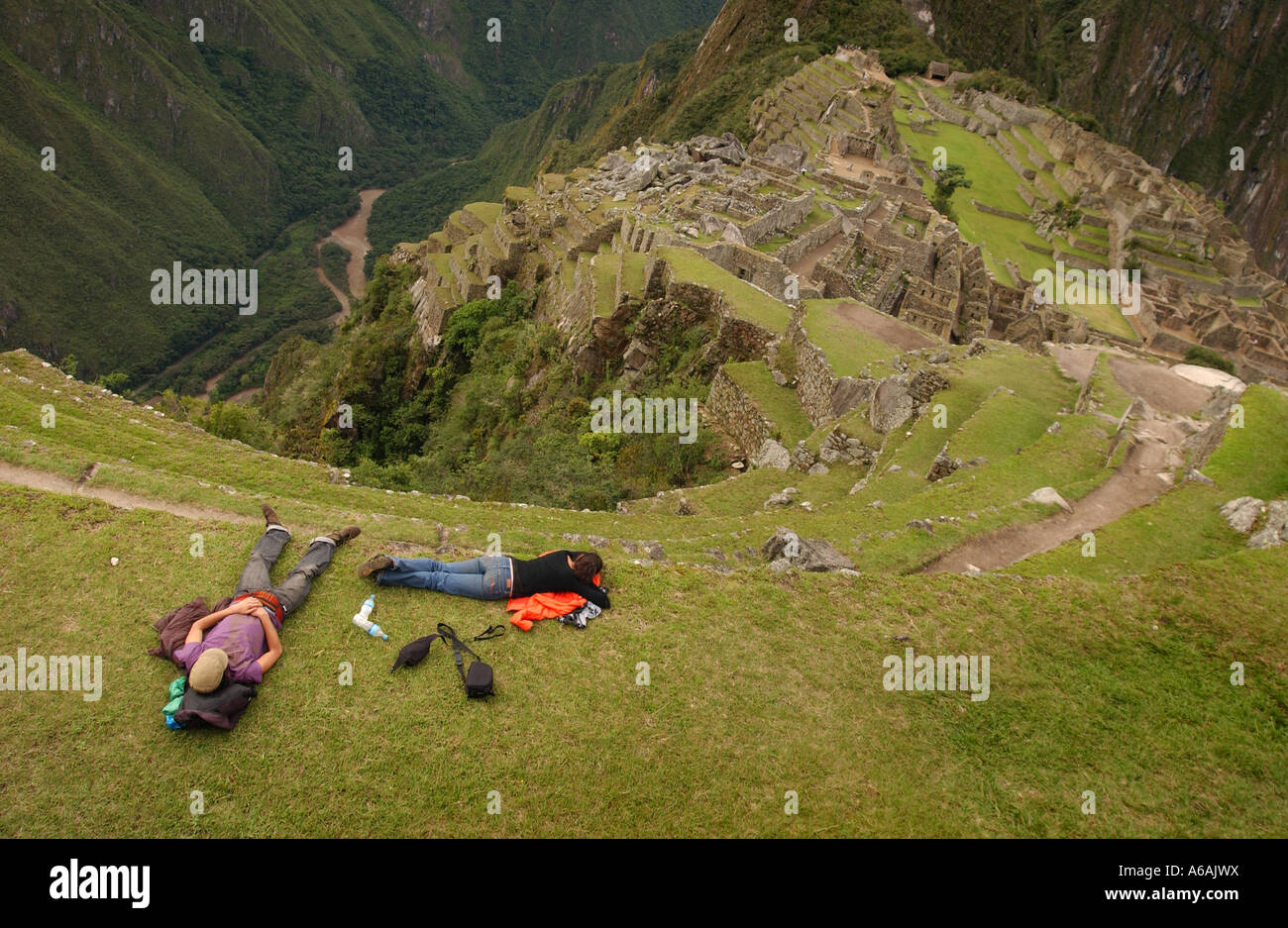 tourists relaxing at the top of Machu Picchu, in Peru, South America ...