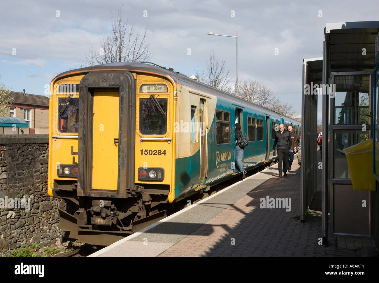 Train in outlying station with people getting off Cardiff Wales UK ...