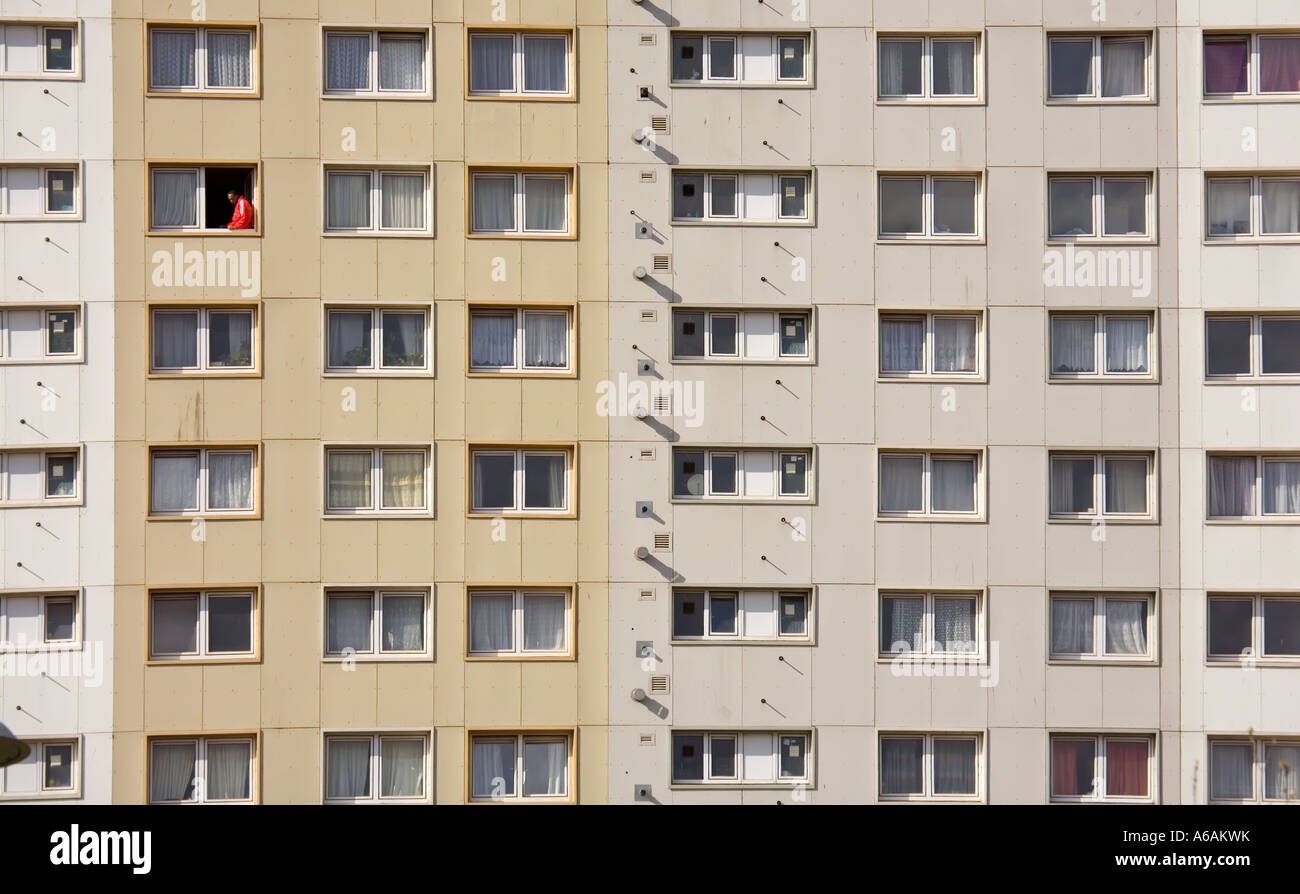 Man sitting in open window of tall block of flats Cardiff Wales UK ...
