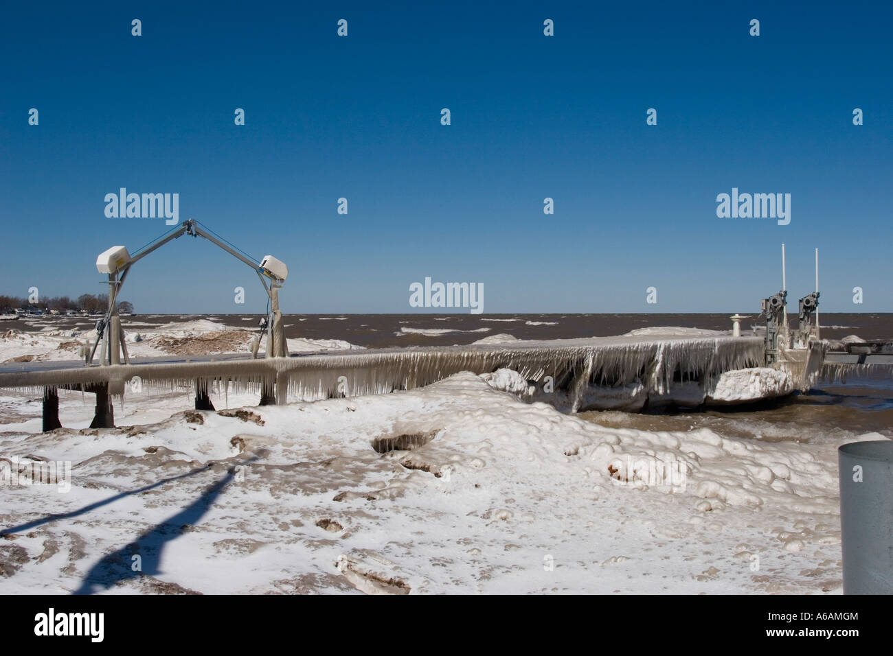 Frozen shore of Lake Ontario at Ontario Bay Rochester with Boat hoist ...