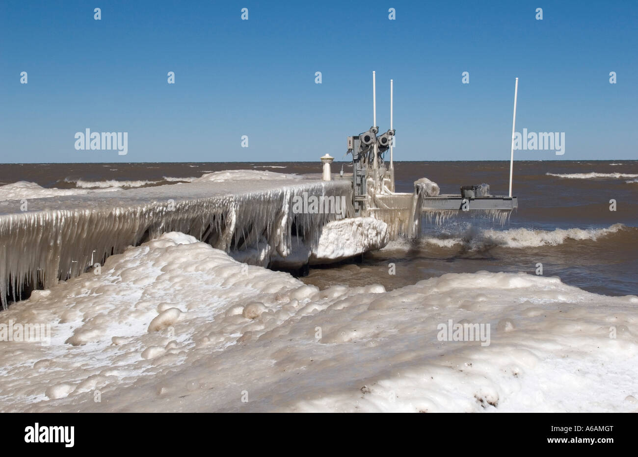 Frozen shore of Lake Ontario at Ontario Bay Rochester with Boat hoist ...