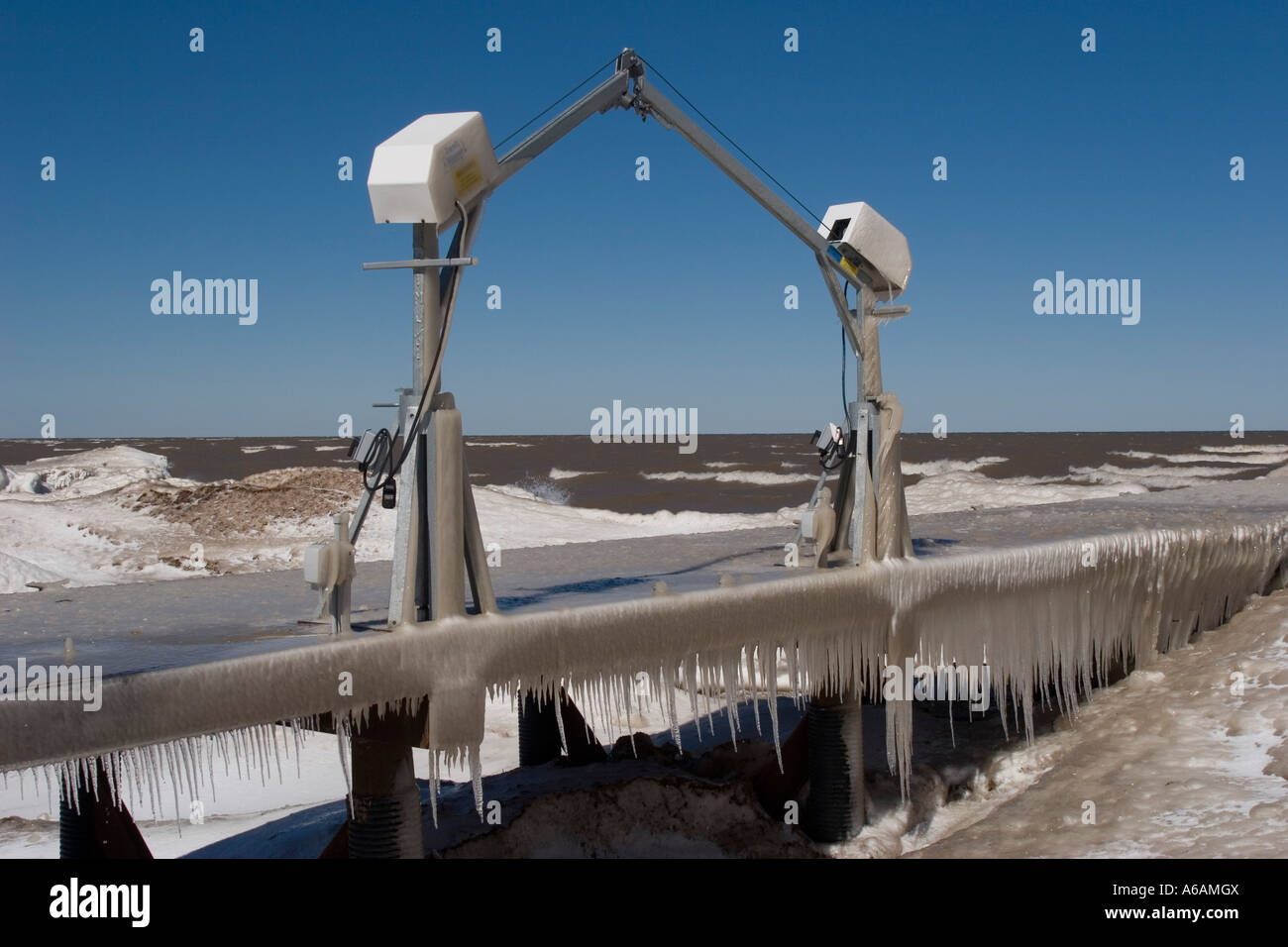 Frozen shore of Lake Ontario at Ontario Bay Rochester with Boat hoist ...