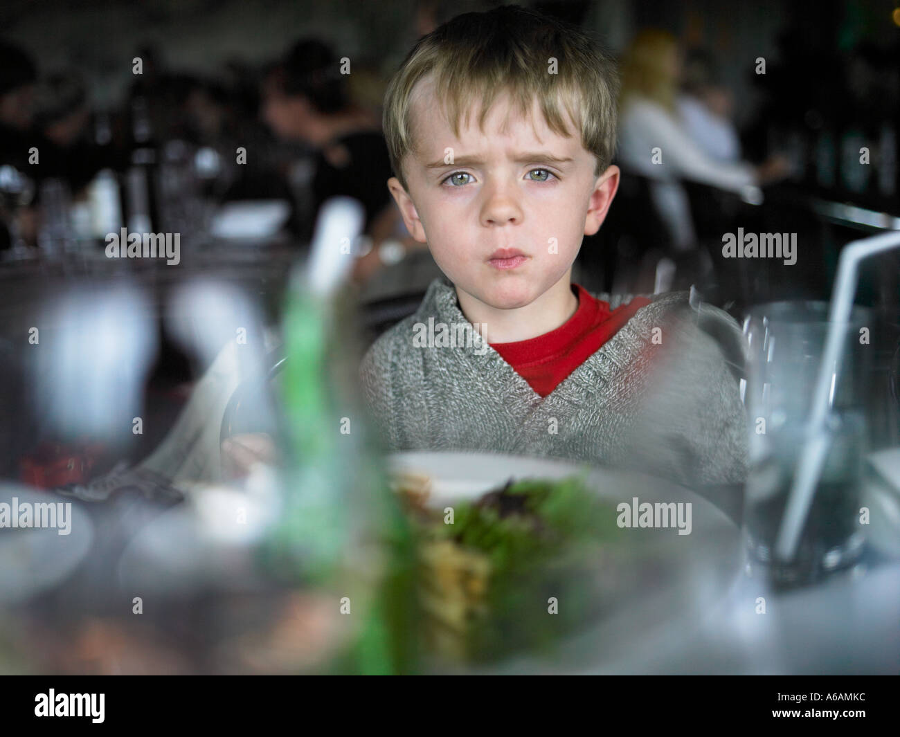 child with mouthful of food chewing in restaurant Stock Photo - Alamy