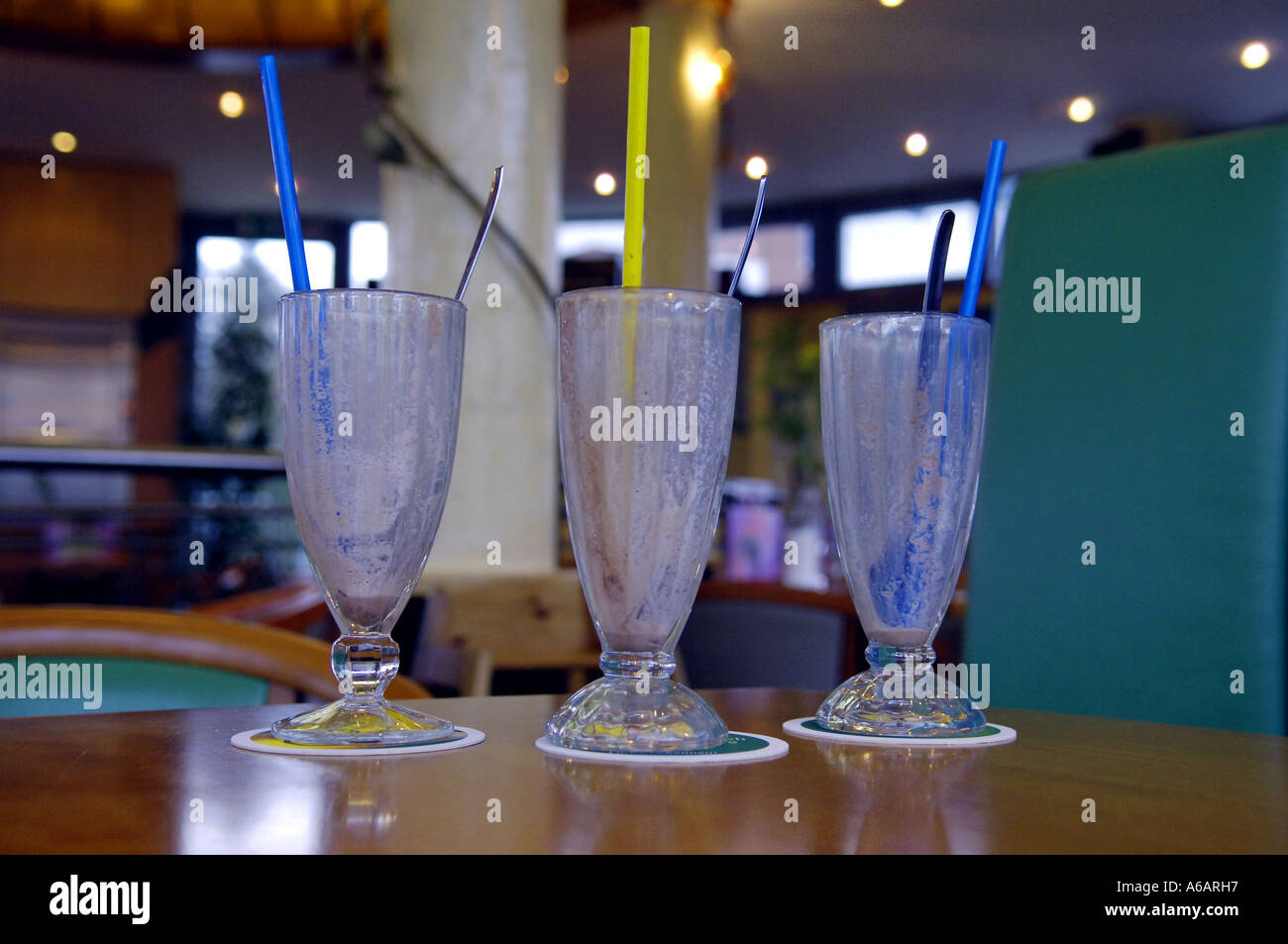 three empty cocktail glasses table straw milkshakes bar refreshment ...