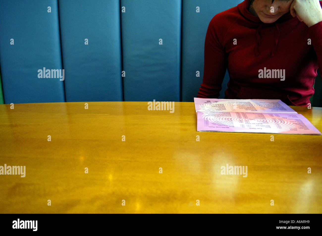 woman reading menu empty table colour color horizontal red blue yellow ...