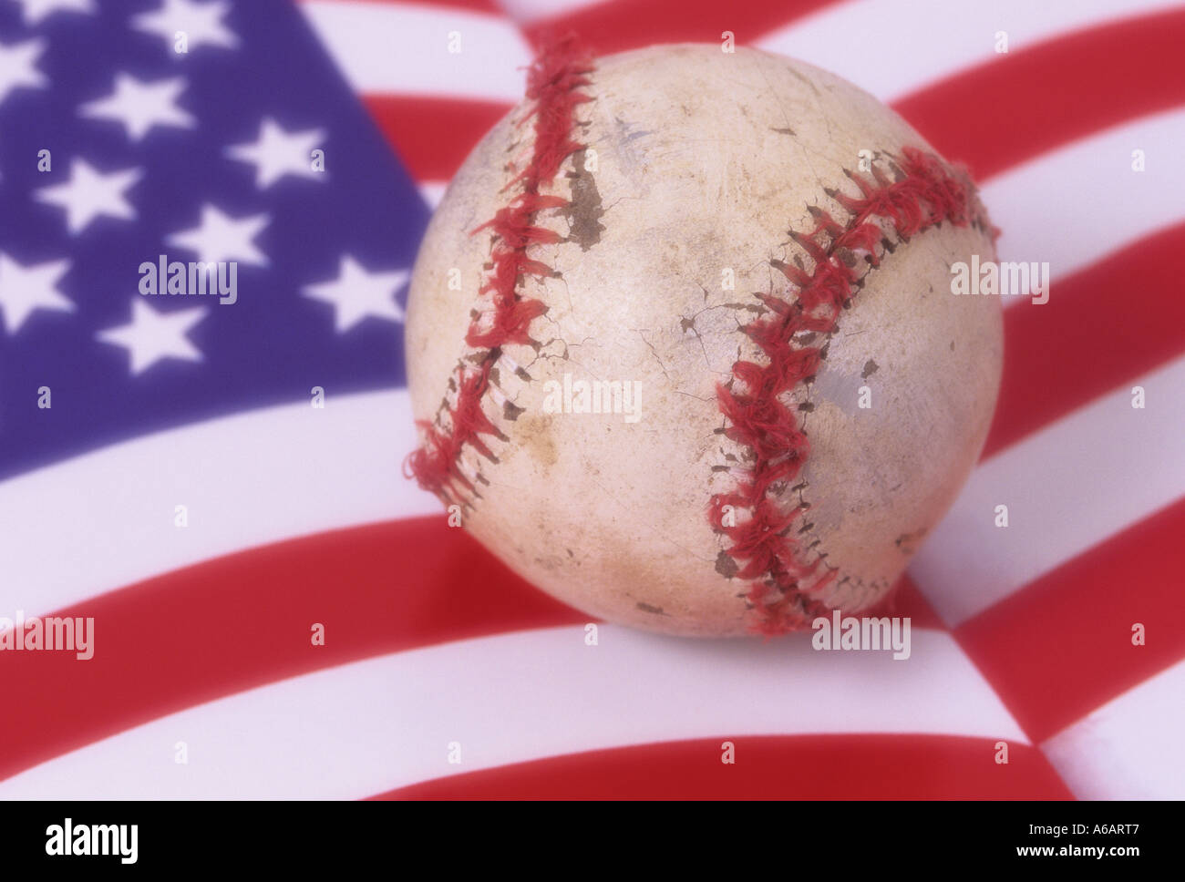 Old tattered used baseball lying on an American flag Stock Photo - Alamy