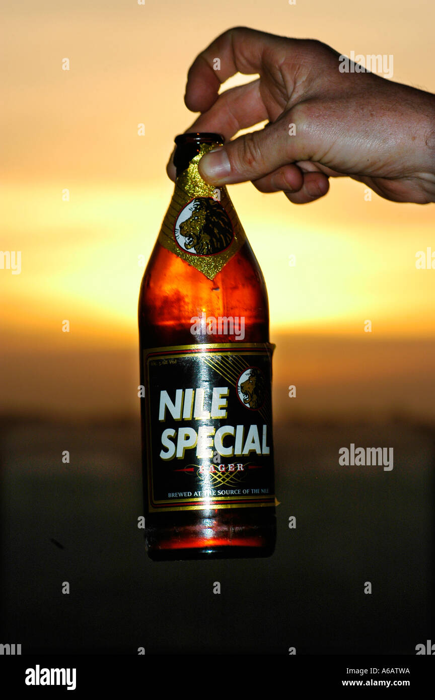 A bottle of Nile Special beer at sunset near the city of Jinja, Uganda ...