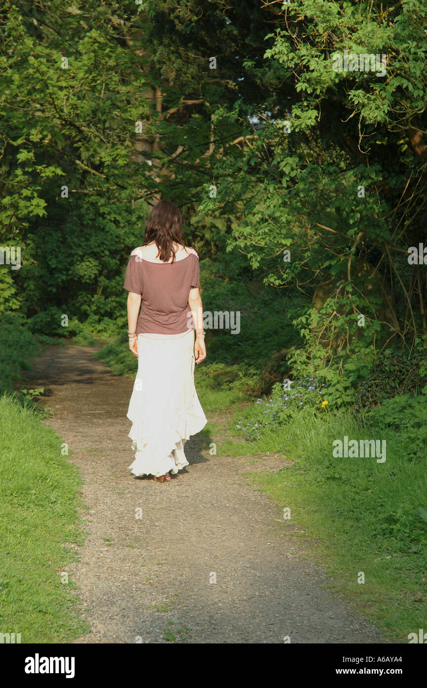 Woman walking alone behind hi-res stock photography and images - Alamy