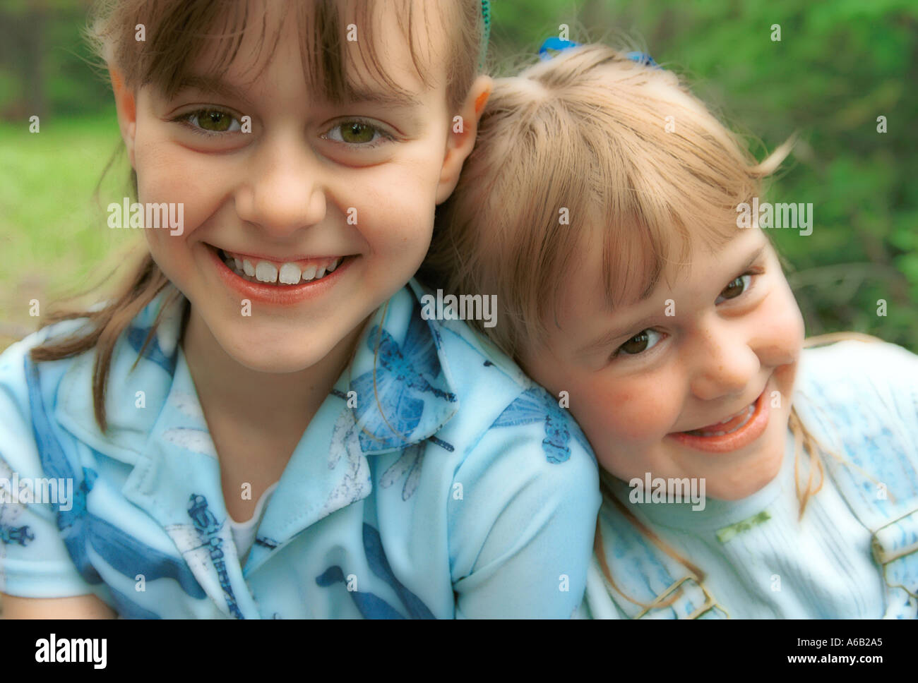 Two sister smiling at camera model released Stock Photo - Alamy