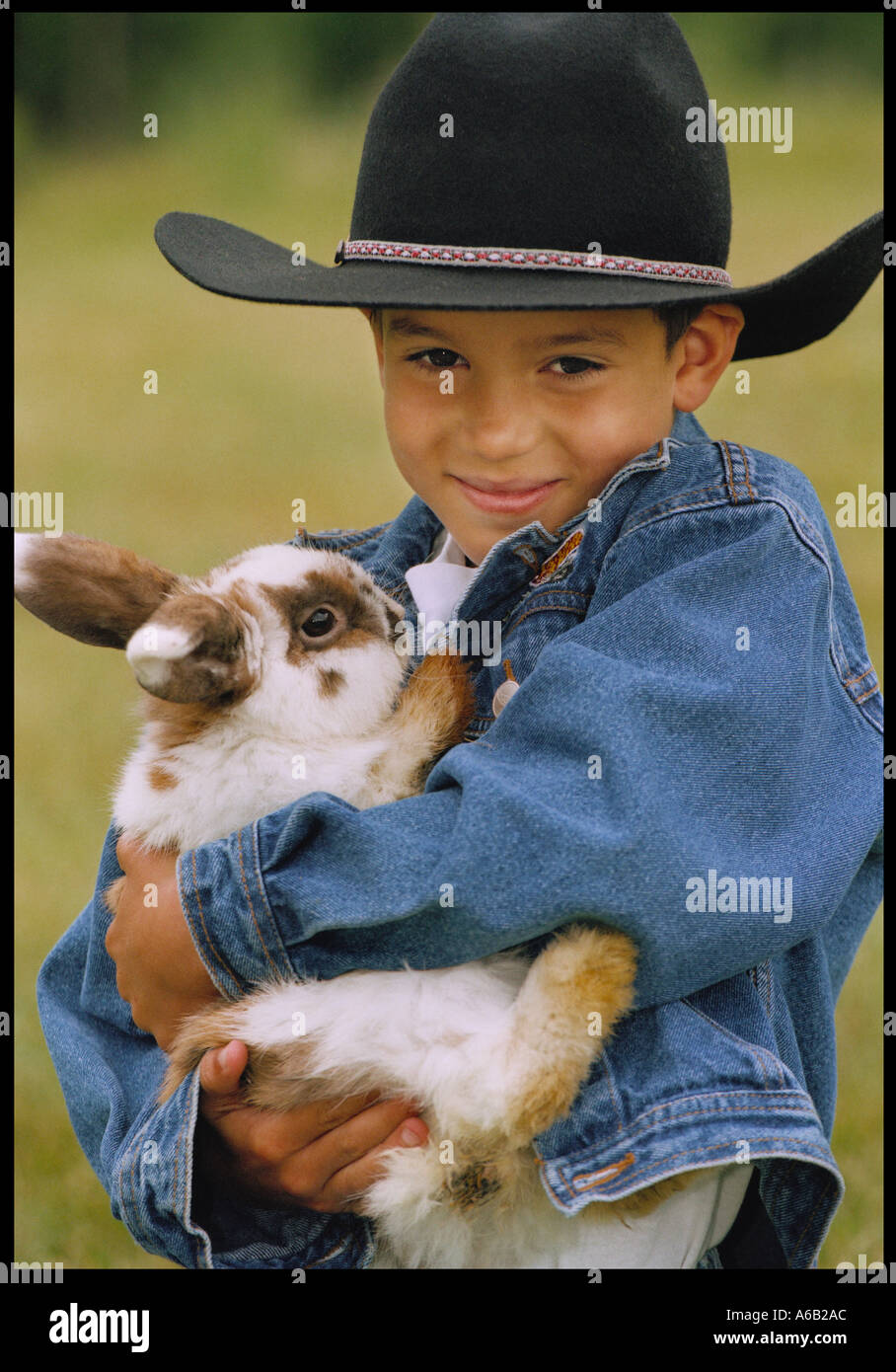 7 year old boy holding rabbit Stock Photo - Alamy