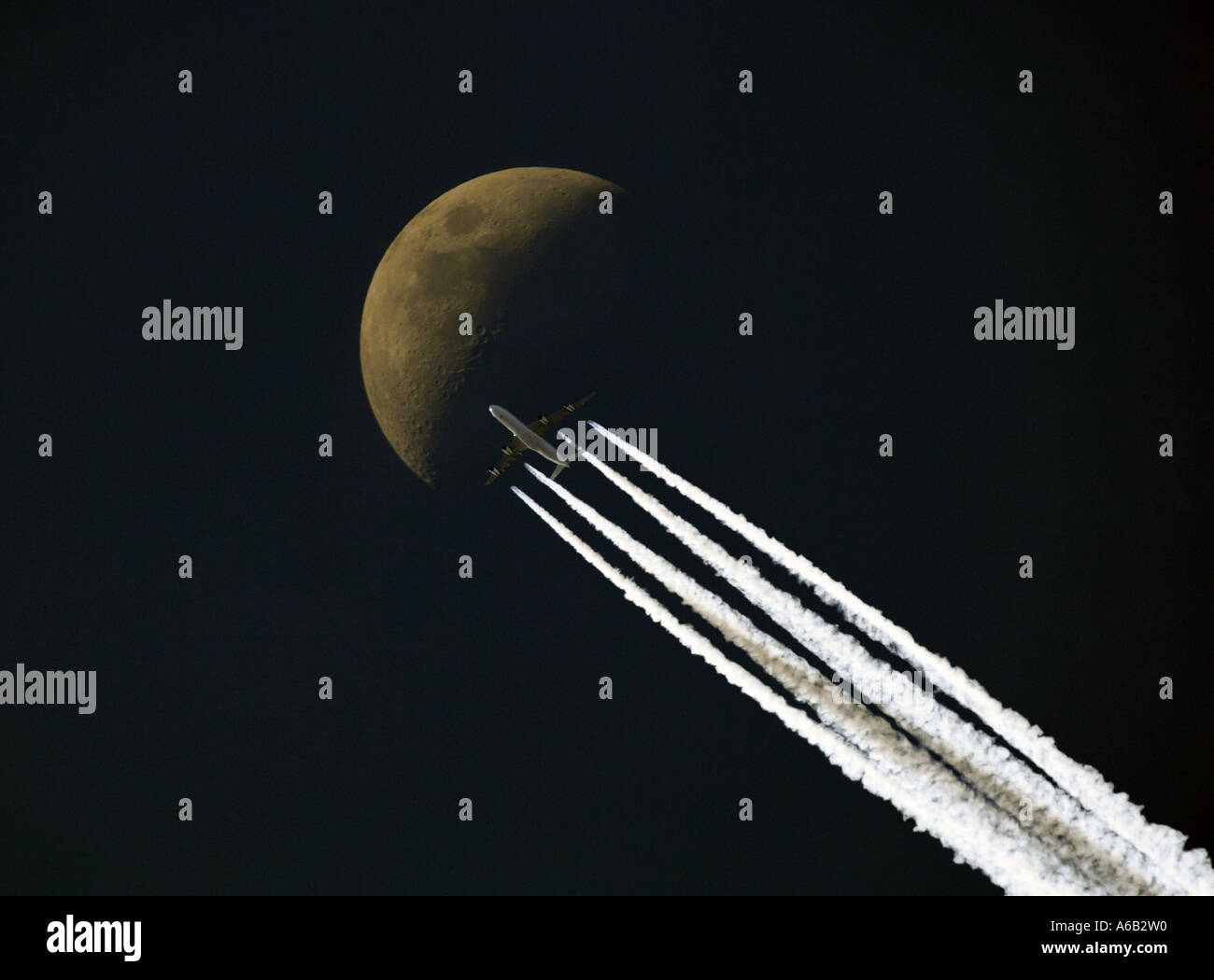 Airbus Boeing with large contrails flying past the moon crescent in ...
