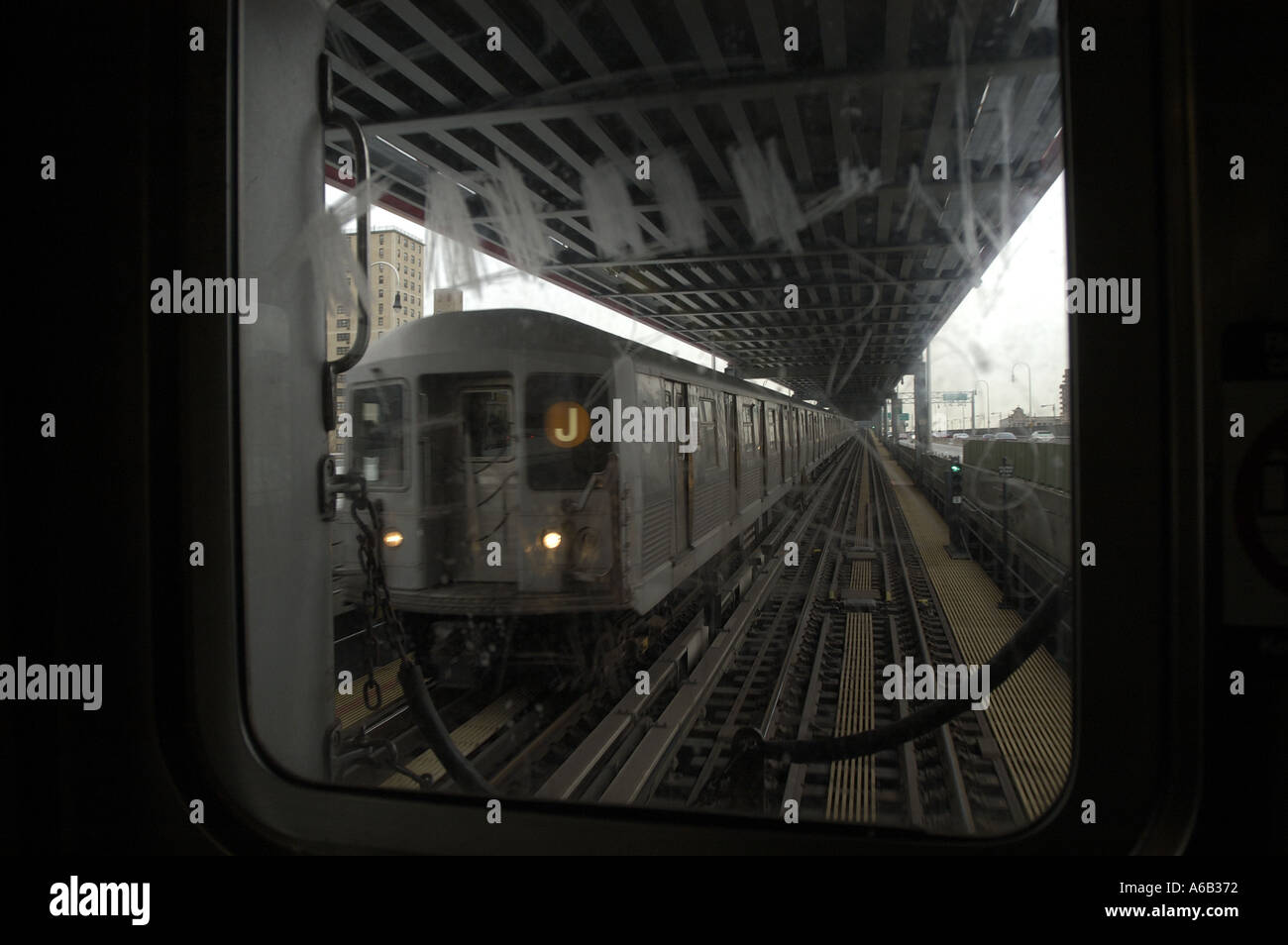 Williamsburg Subway bridge grid metal pillars commuters train station metro NY struts window ...