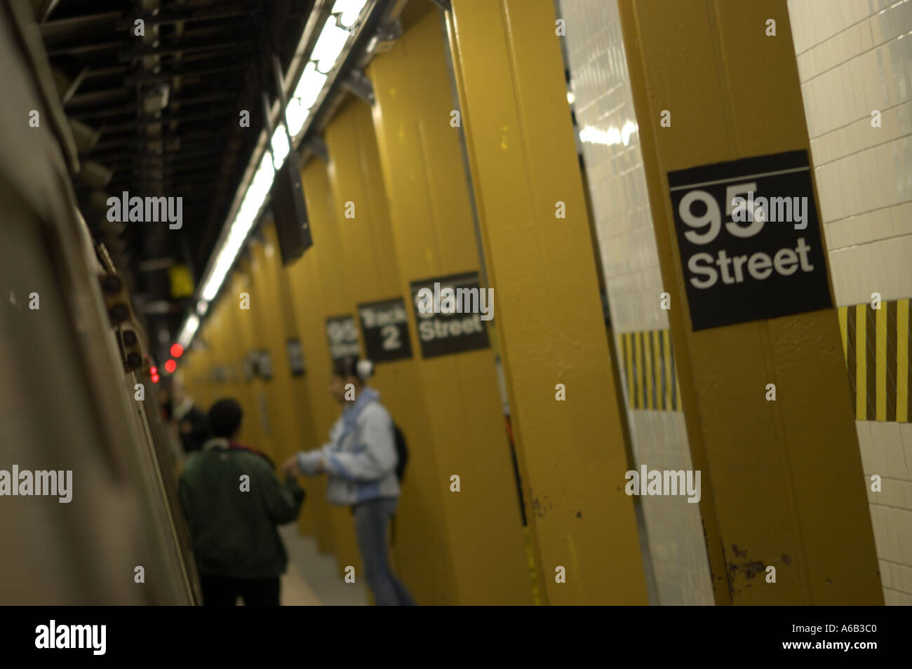 Subway platform yellow pillars commuters train station metro NY ...