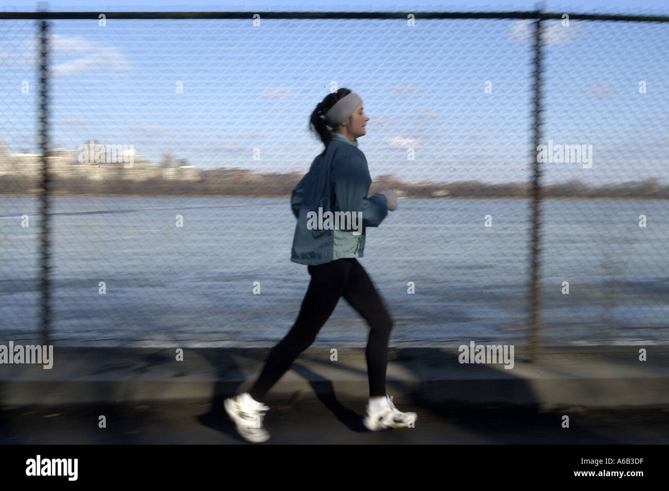 Jogger running alongside the Central Park Reservoir Stock Photo - Alamy