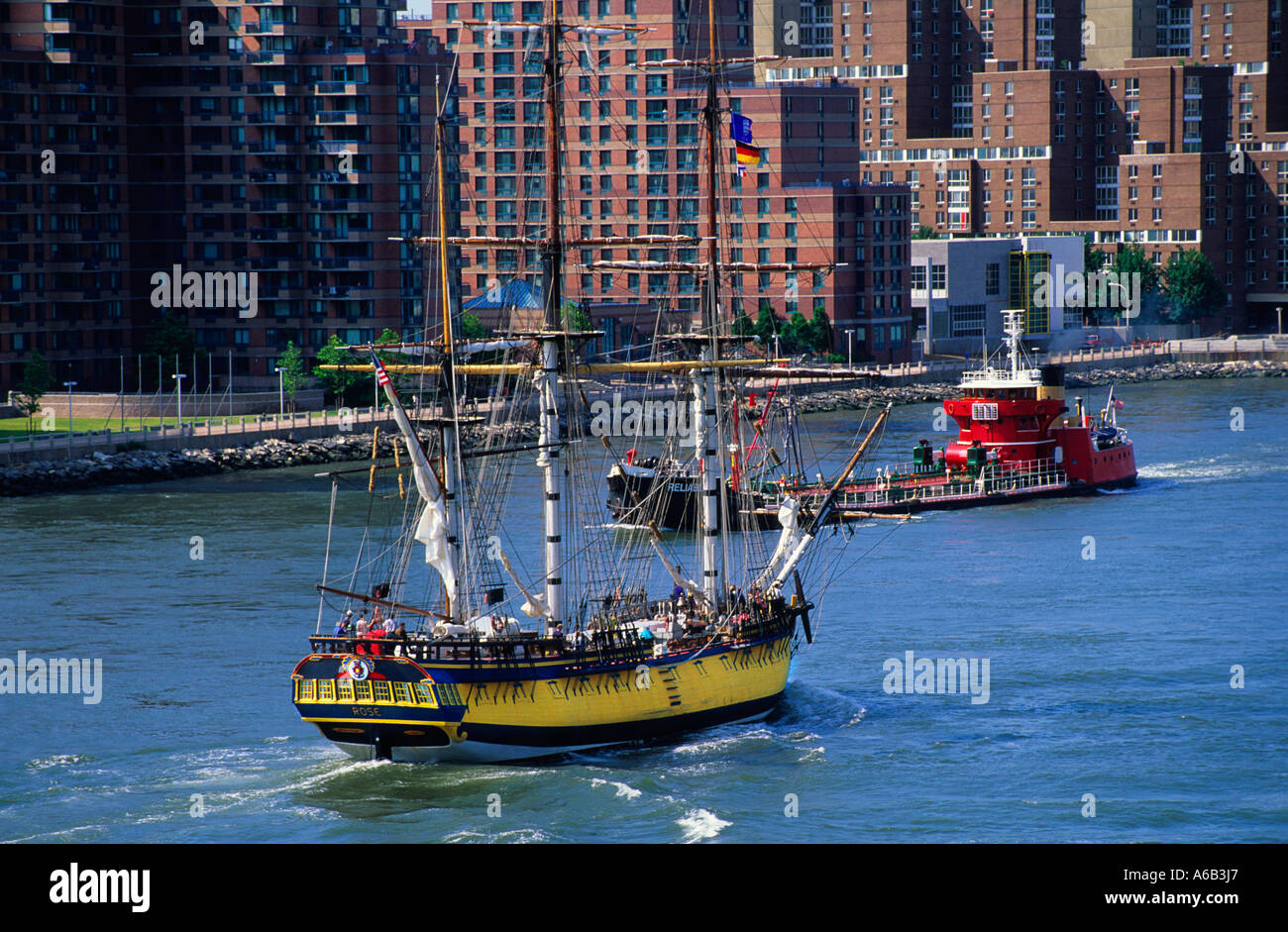 Oil tanker or fuel tanker guided by tugboat. Vintage schooner with ...