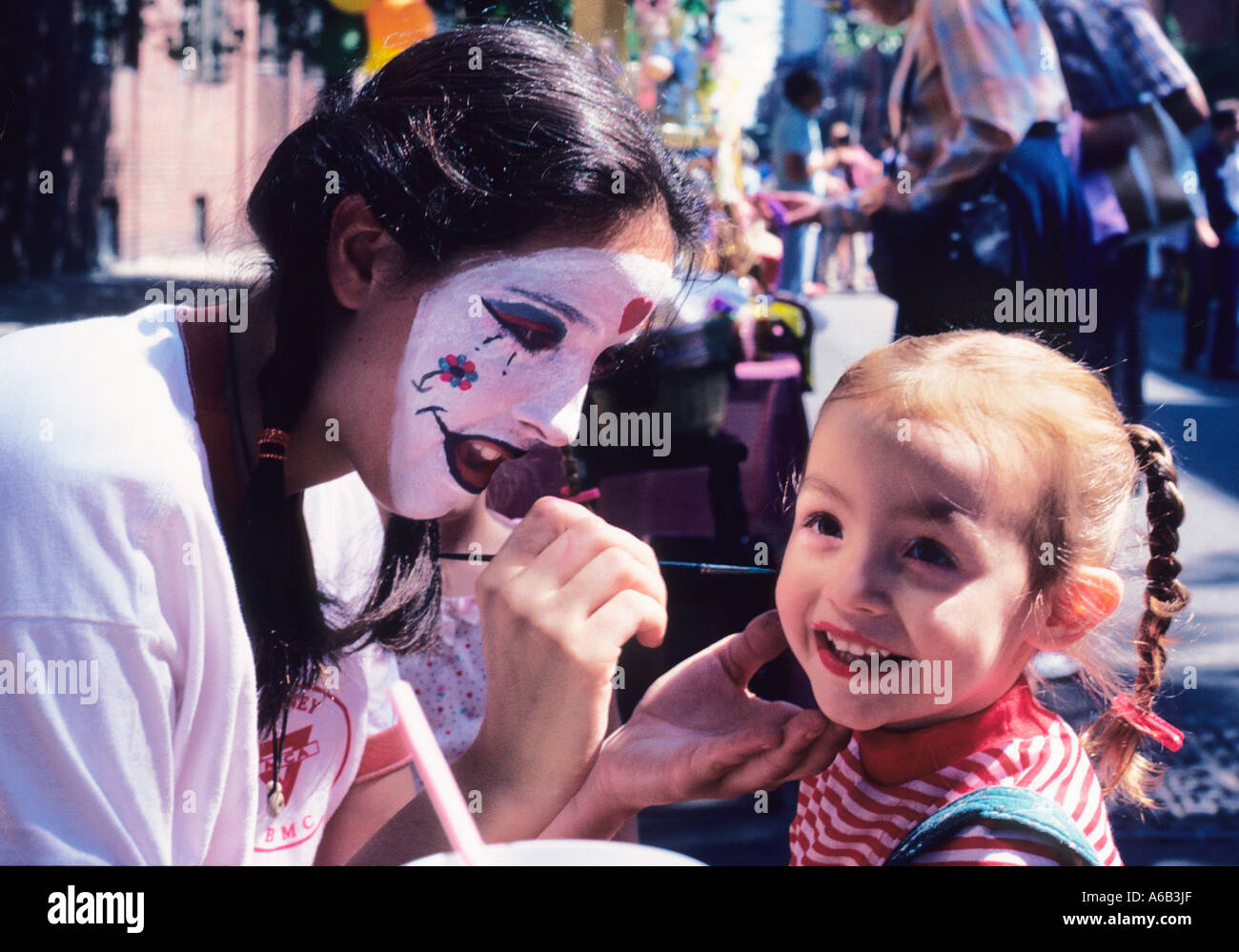 Street Fair Young Girl Having Her Face Painted by an Artist at a Block ...