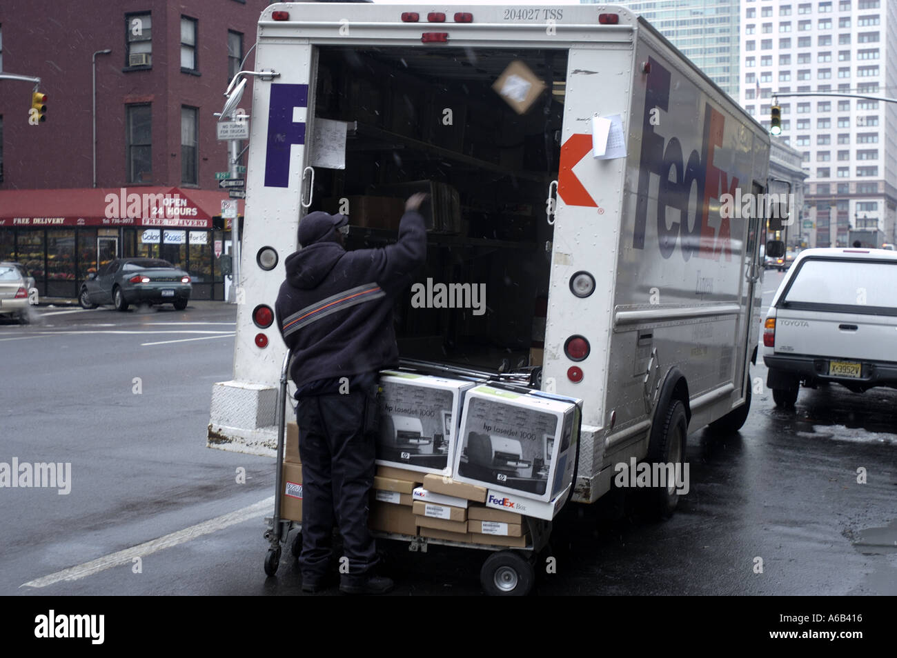 Fedex truck delivery delivering open packages horizontal Stock Photo ...