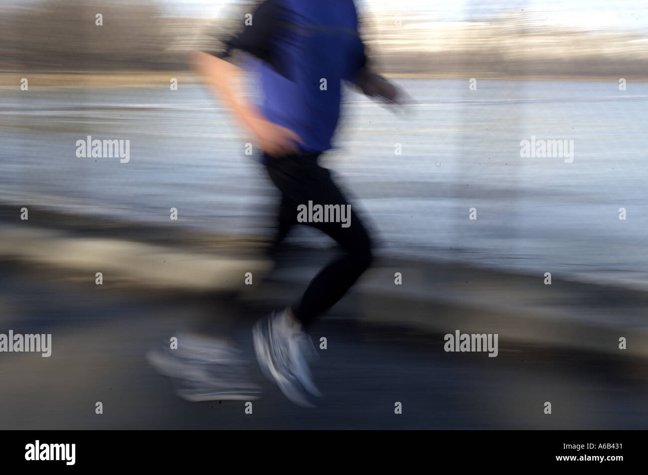 Jogger running alongside the Central Park Reservoir Stock Photo - Alamy