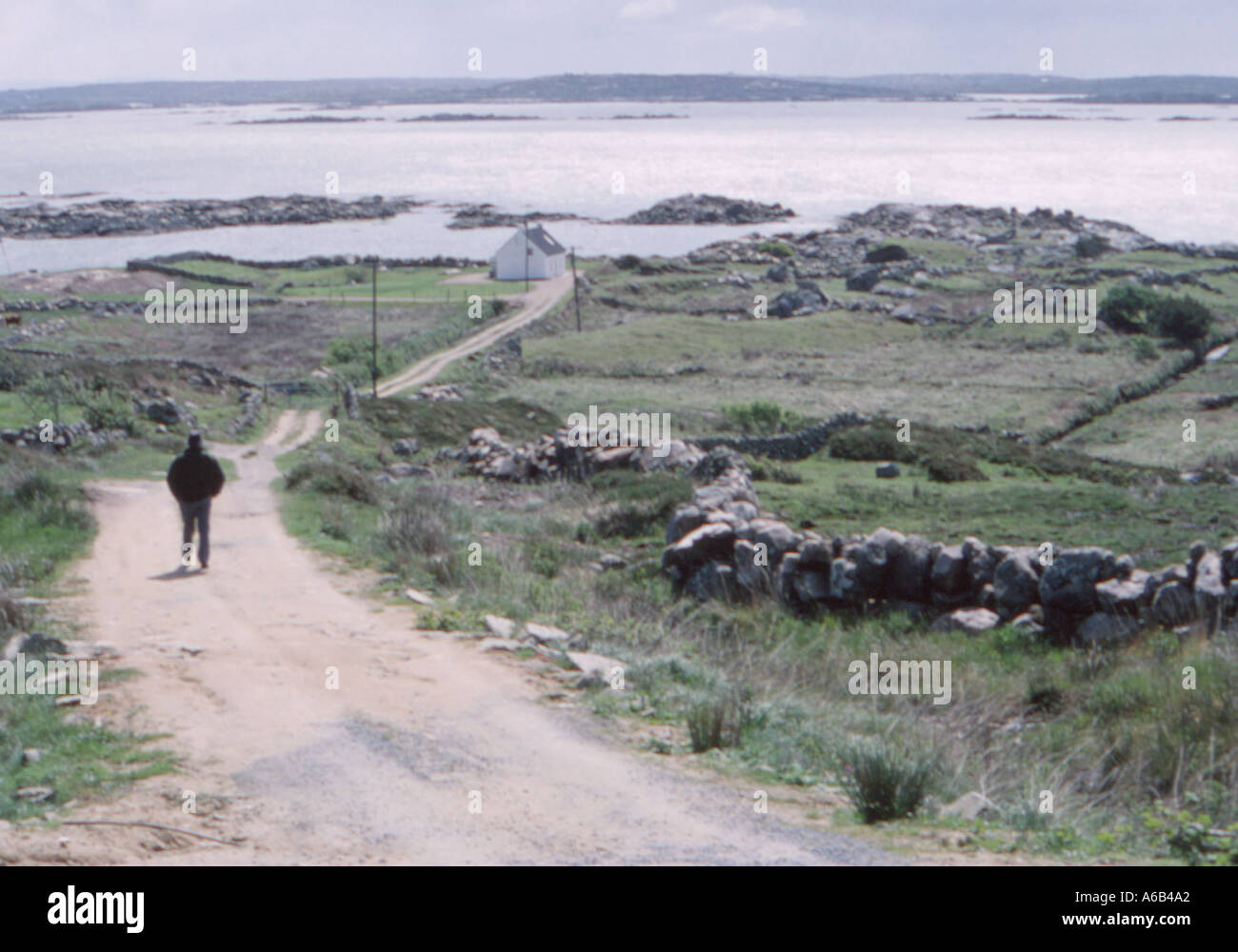 old man walking home along path in Ireland by the sea Stock Photo - Alamy