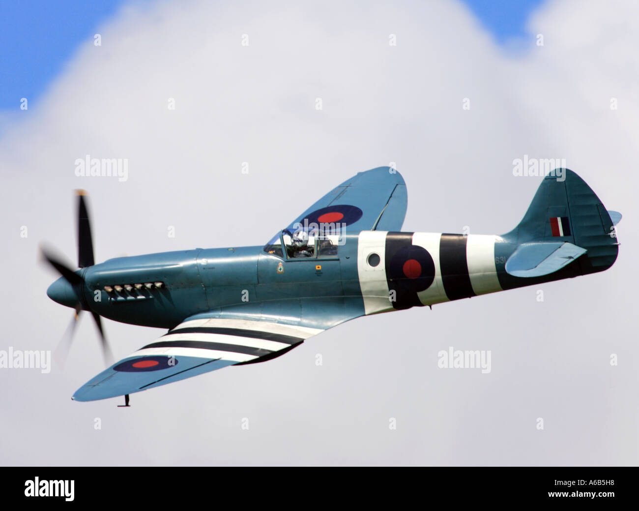 Supermarine Spitfire bearing Invasion stripes in flight Stock Photo - Alamy