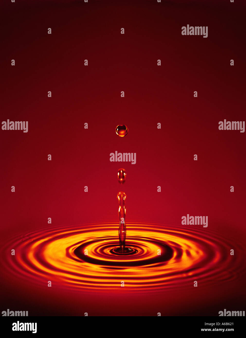 DROPLET WITH RIPPLES IN RED LIQUID Stock Photo - Alamy