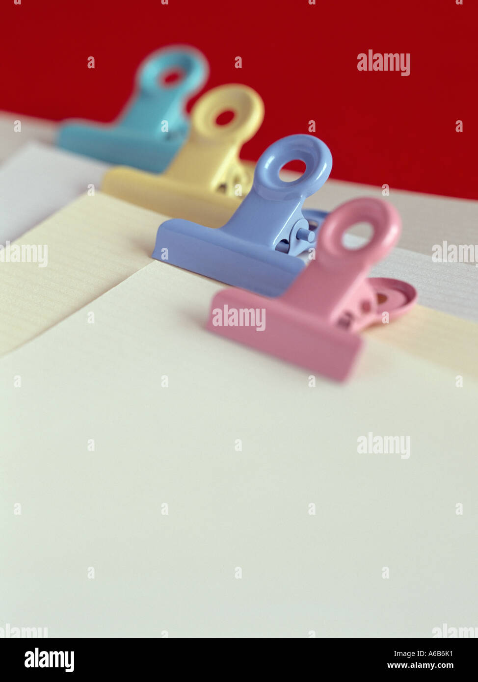 Paper with Coloured Bulldog Clips Stock Photo - Alamy