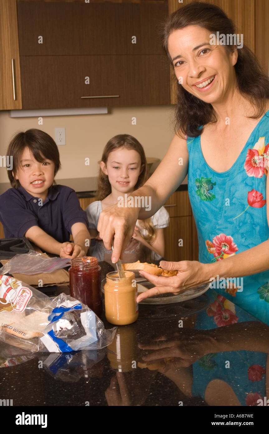 Portrait of mother making lunch for kids Stock Photo - Alamy