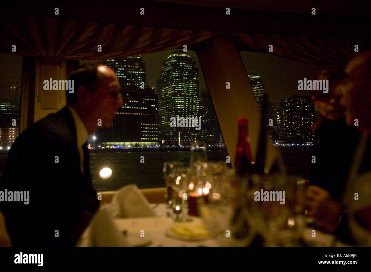 Nighttime diner on a yacht sailing around Manhattan New York City USA ...