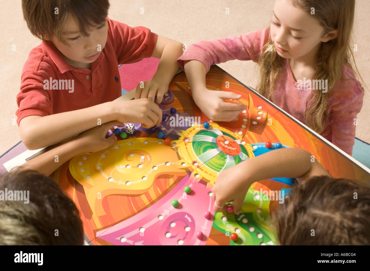Portrait of kids playing a board game Stock Photo - Alamy