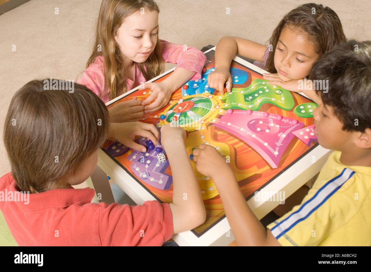 Portrait of kids playing a board game Stock Photo - Alamy
