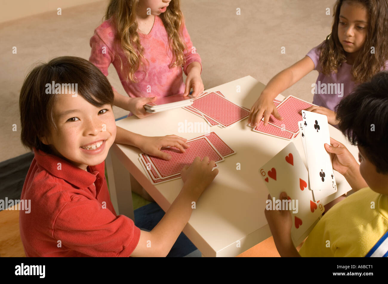 Portrait of kids playing cards Stock Photo - Alamy