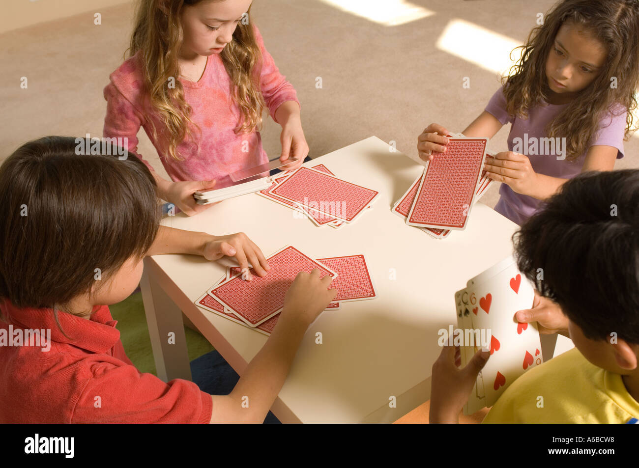 Portrait of kids playing cards Stock Photo - Alamy