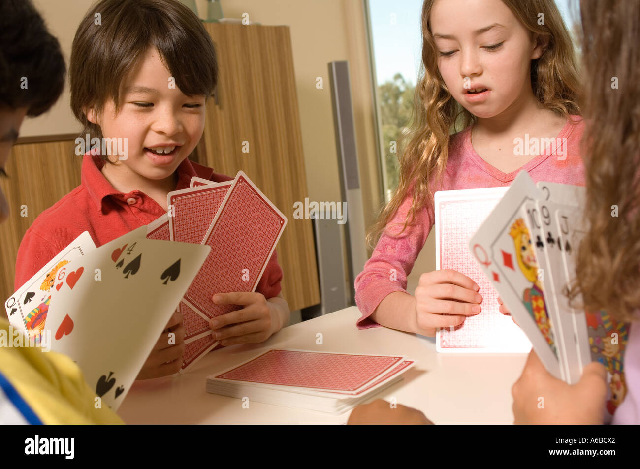 Portrait of kids playing cards Stock Photo - Alamy