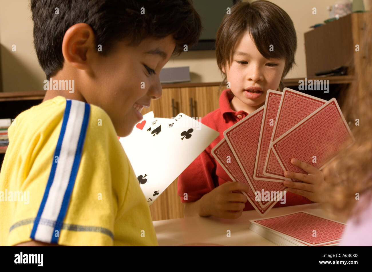 Four friends playing game cards hi-res stock photography and images - Alamy