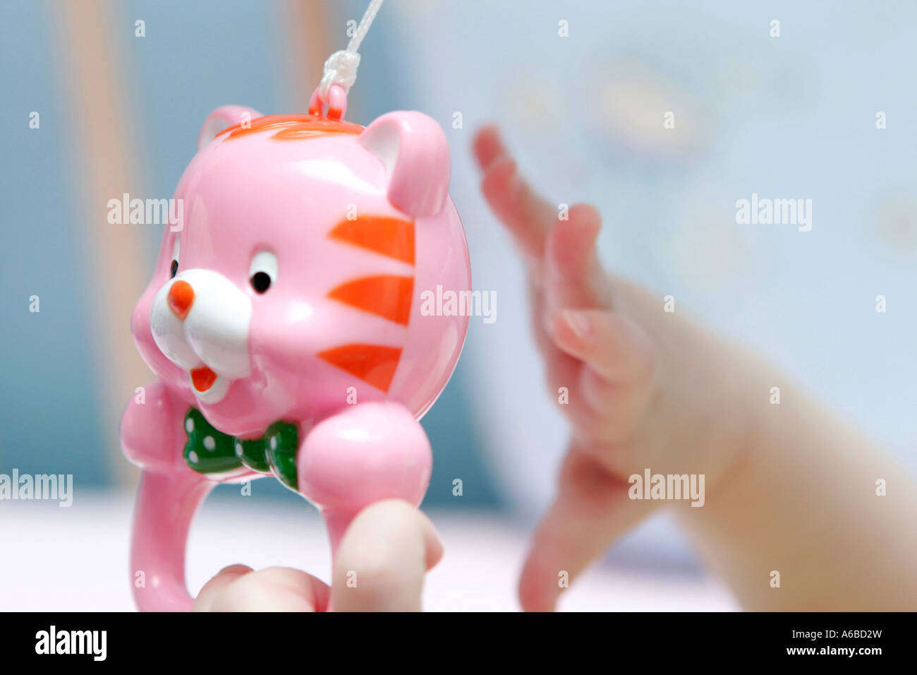 Baby hand holding rattle toy detail hi-res stock photography and images ...