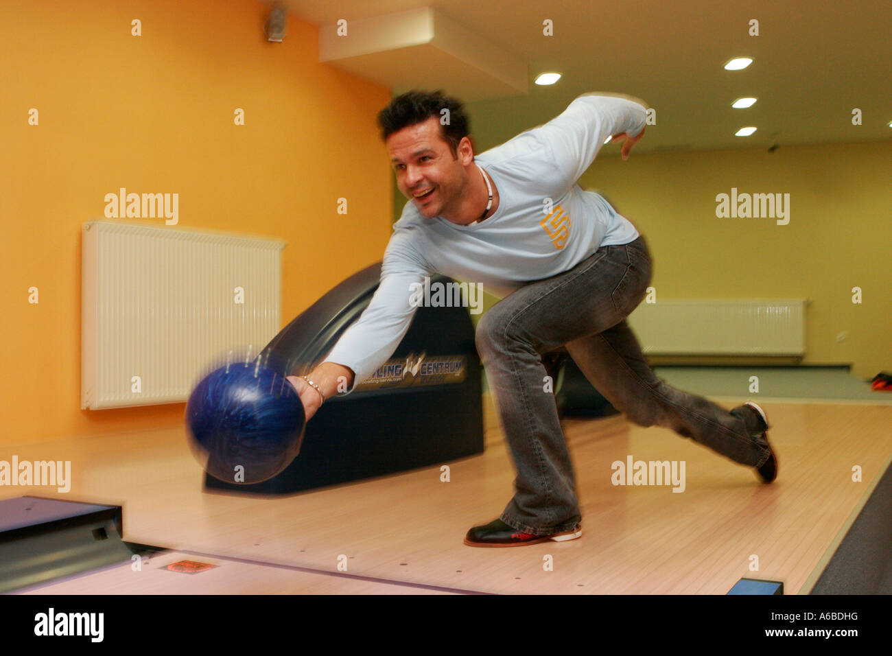 Man playing bowling Stock Photo - Alamy
