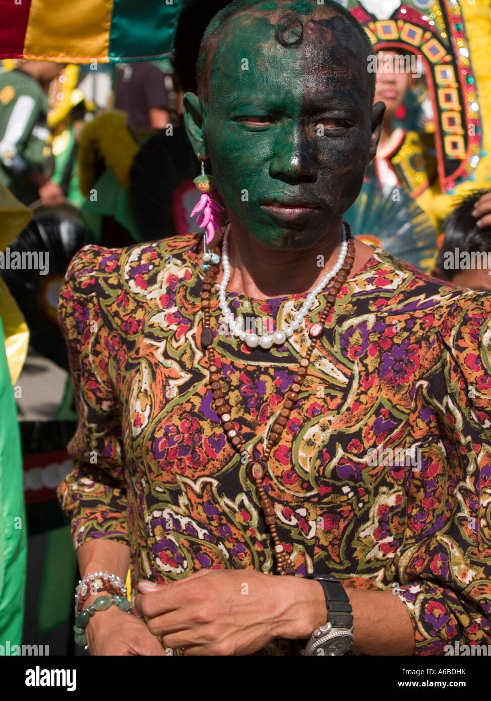 Man in green face and colorful dress all part of the wacky Ati Atihan ...