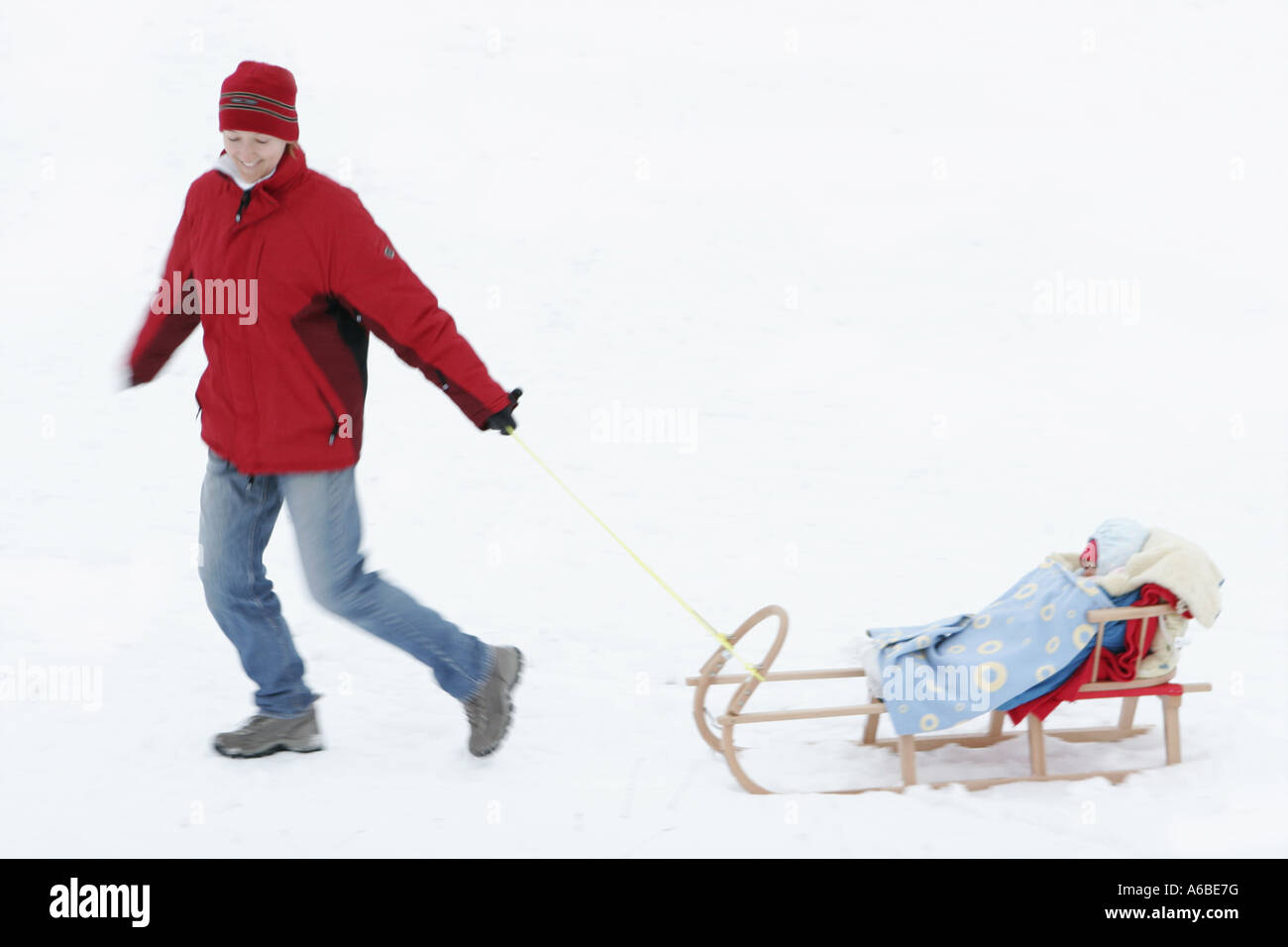 Mother and Baby on Sledge Stock Photo - Alamy