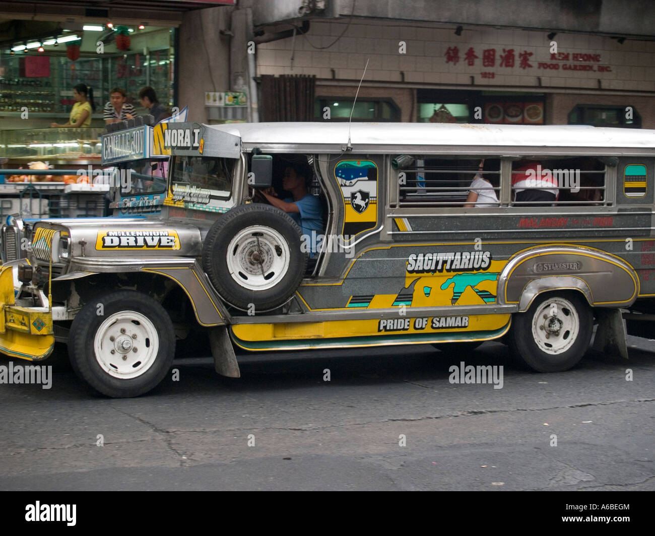 colorful jeepney driving through Chinatown Manila Philippines Stock ...