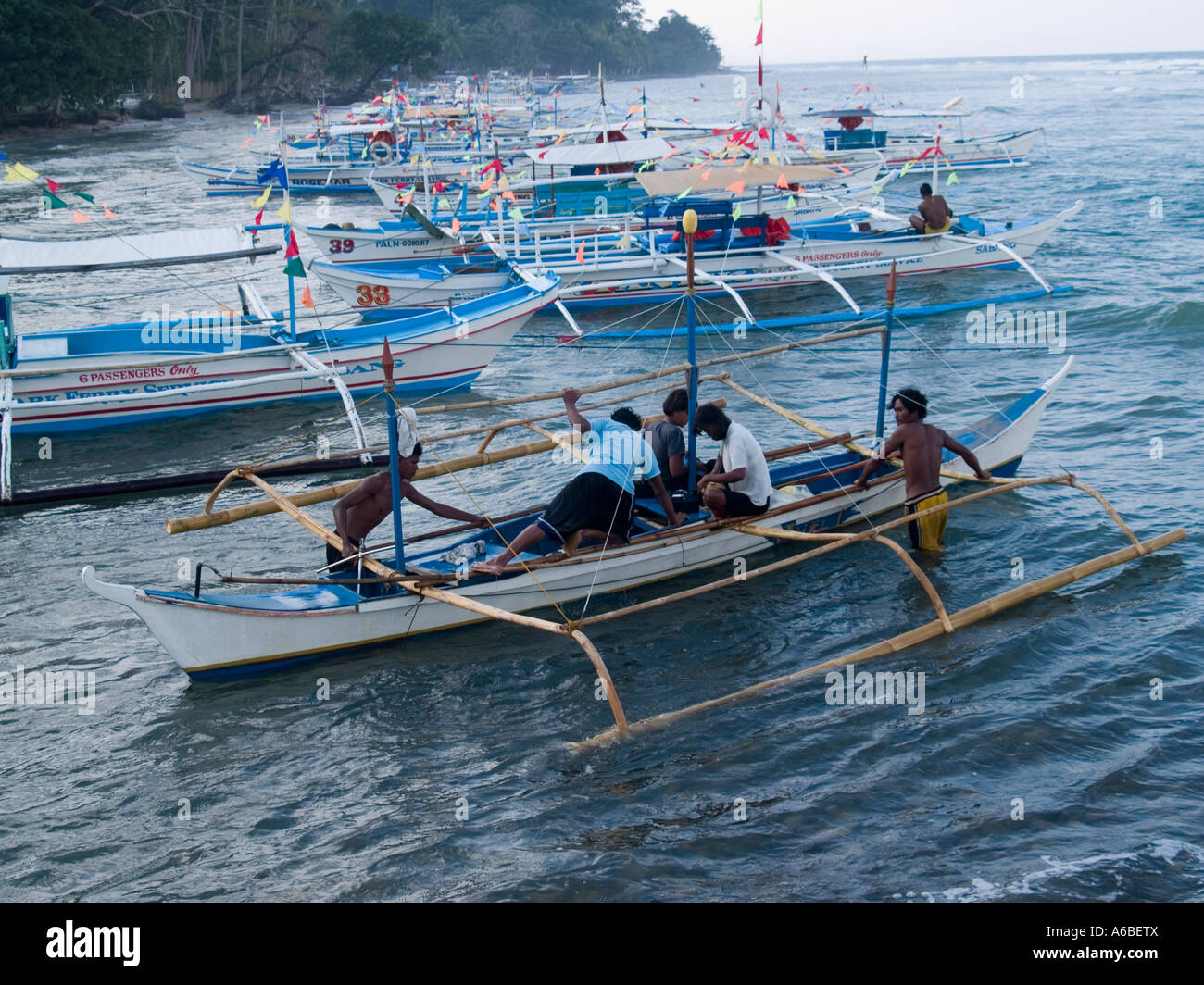 colorful traditional Filipino bancas anchored off the wild Palawan ...