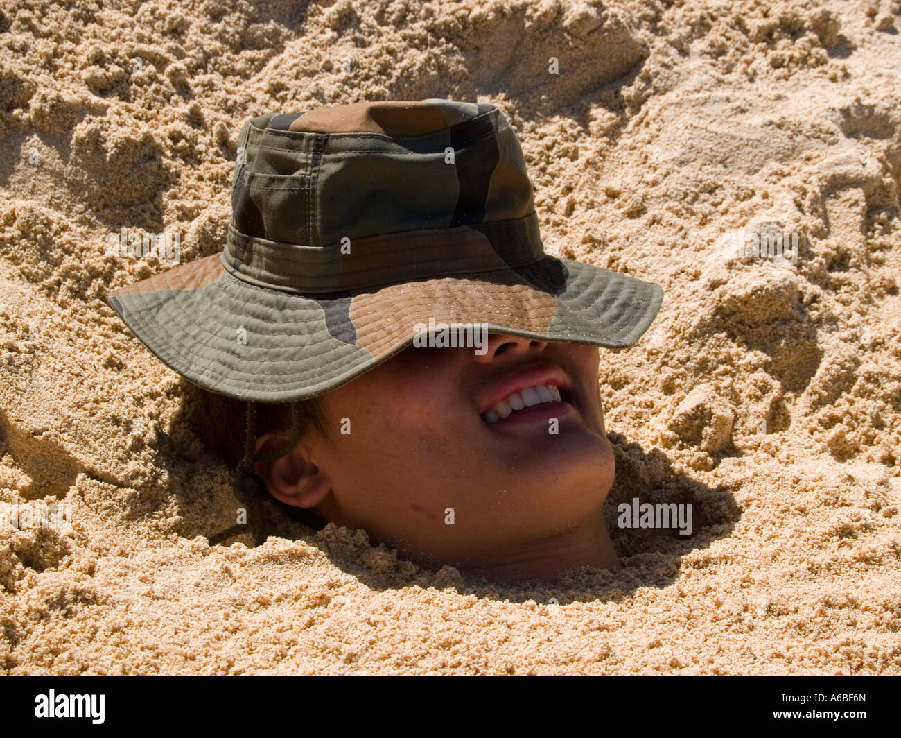 buried in the sand traveler on a beach in the Philippines Stock Photo ...