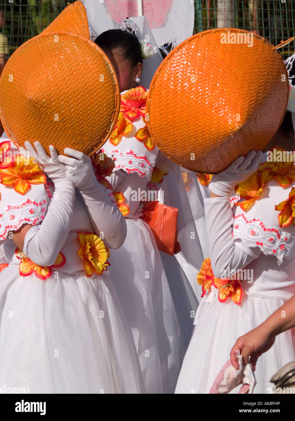 hiding behind hats 2 women shield themselves from the sun Sinulog ...