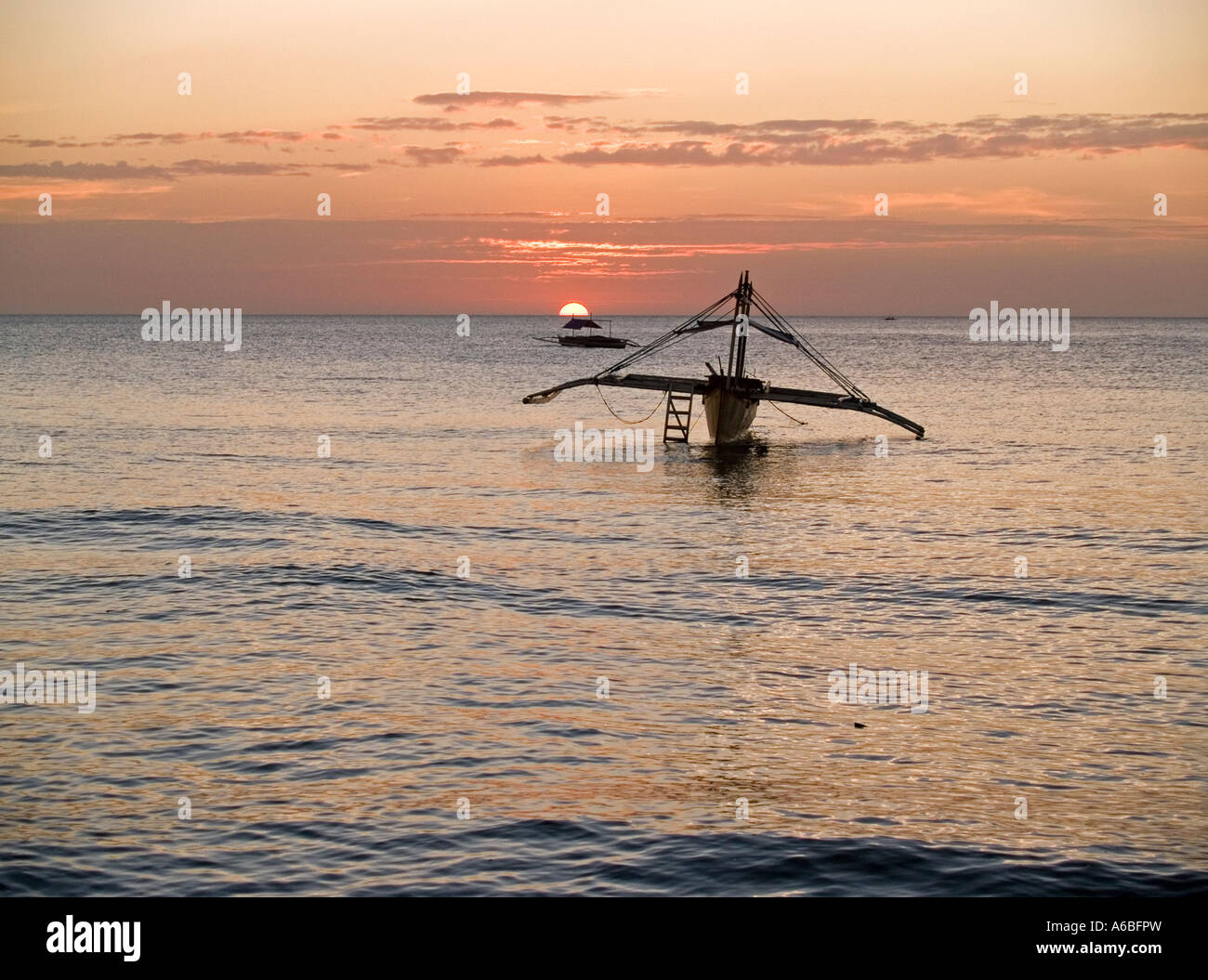 traditional Filipino banca in the water at sunset Sipalay Negros ...