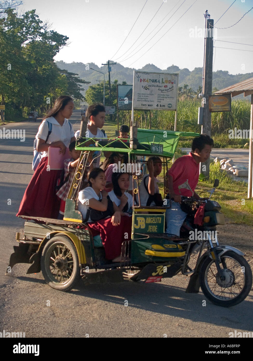 schoolkids going to class on local tricycle Negros Philippines Stock ...